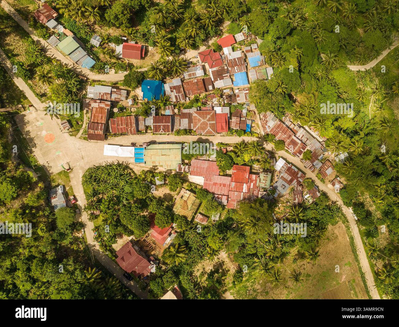 Aerial view of colourful rooftops and road in Dalaguete, Philippines ...