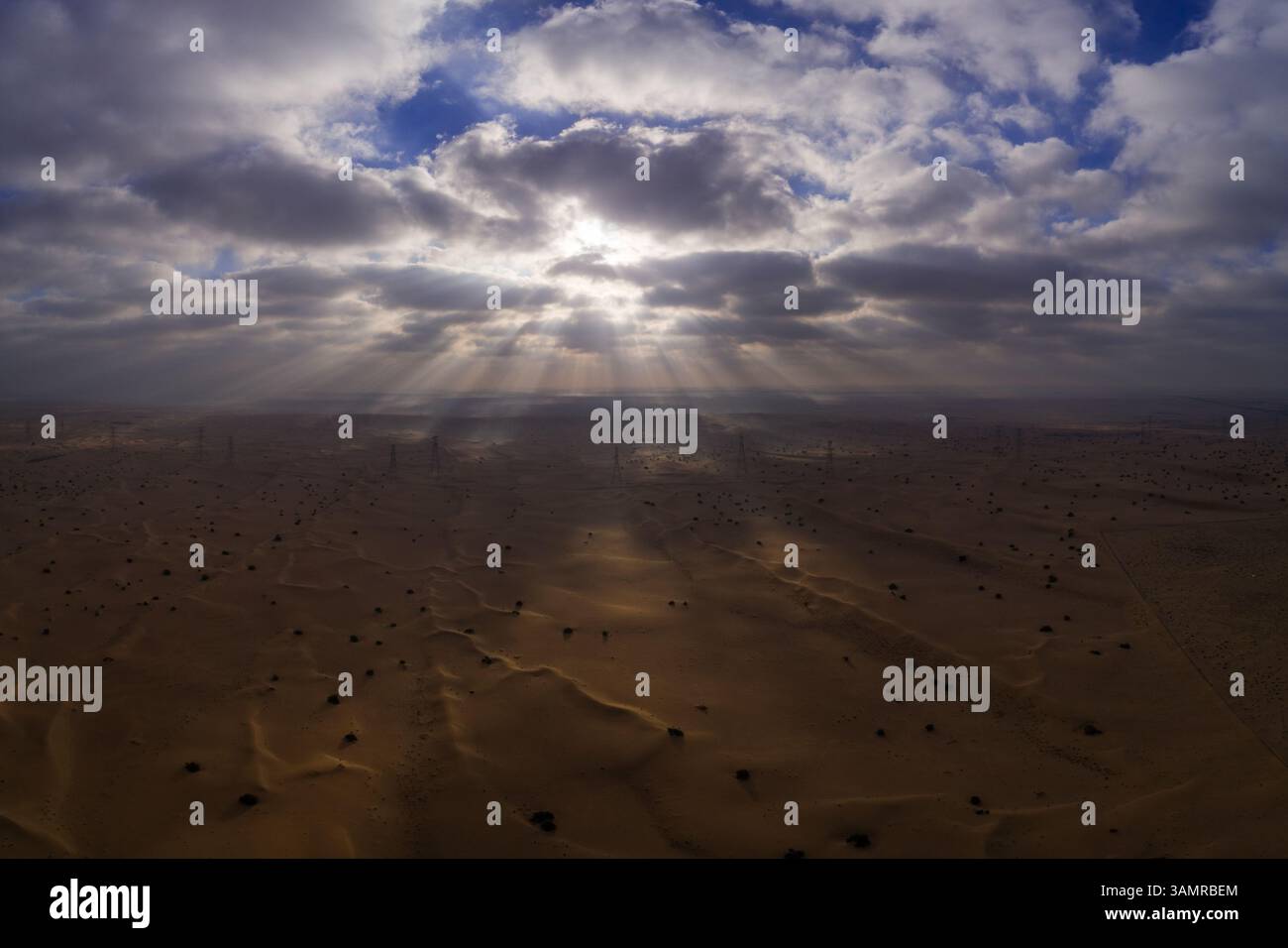 Aerial view of sunlight and clouds above desert and dunes in Dubai, UAE ...