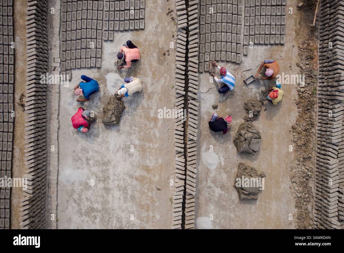 Aerial view of a brick factory from above, people working arranging the ...