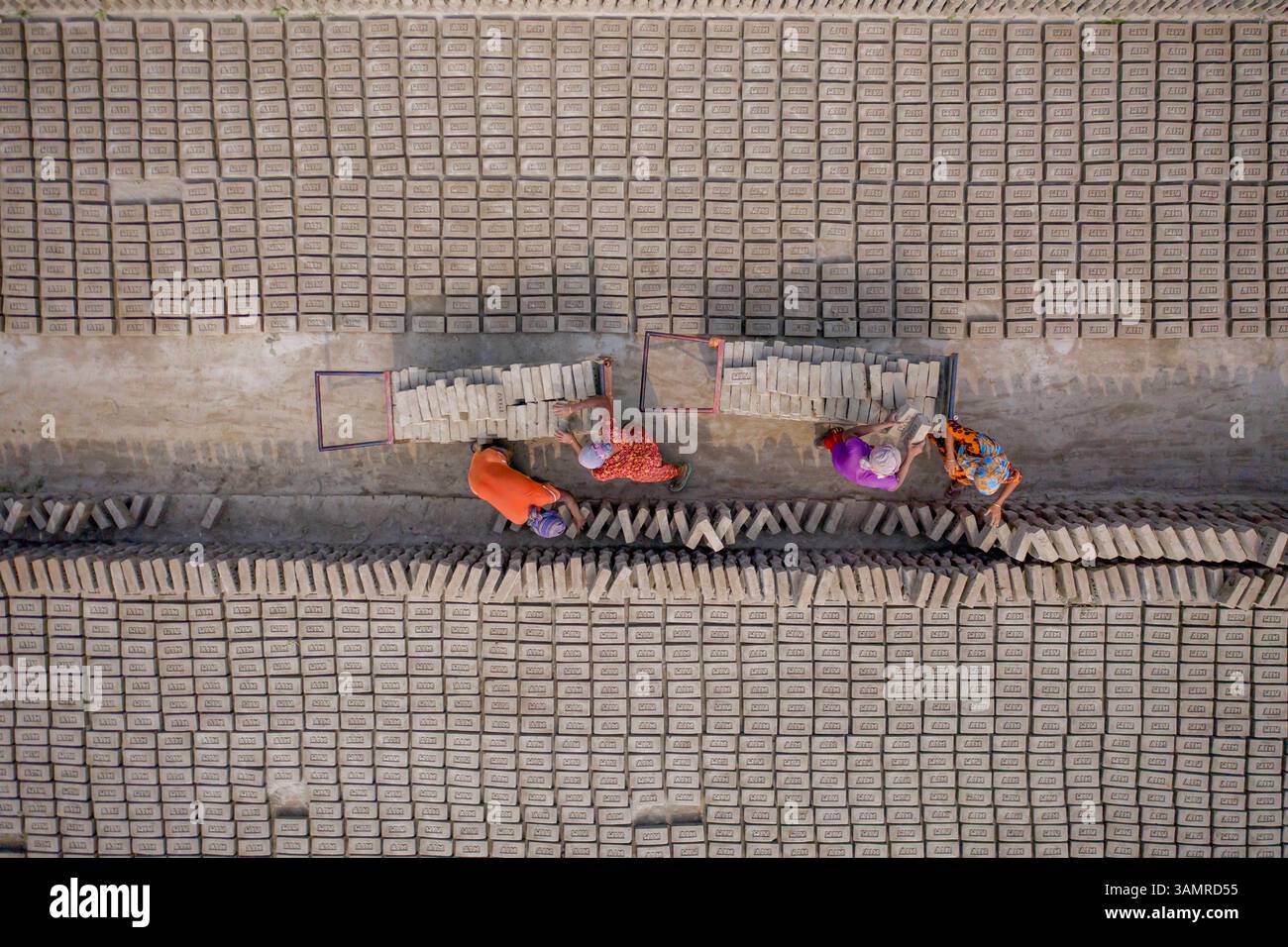 Aerial view of a brick factory from above, people working arranging the ...
