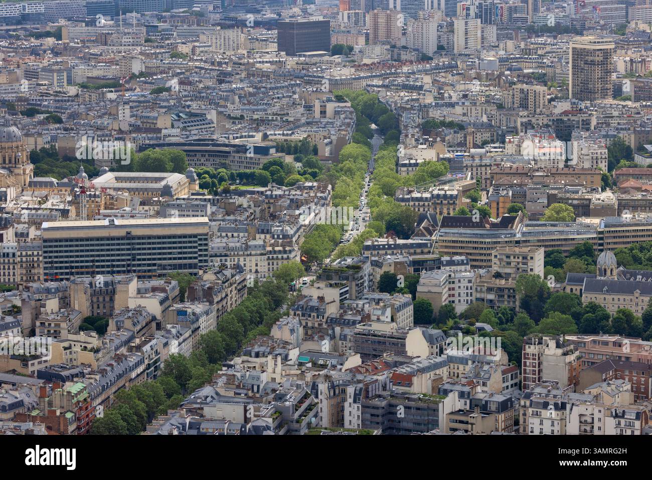 Aerial view of dense rooftops and greenery in metropolitan Paris ...