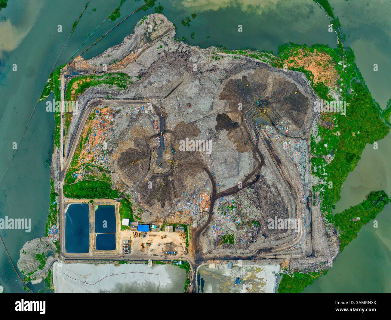 Aerial view of cranes working at the largest waste dumping yard in ...