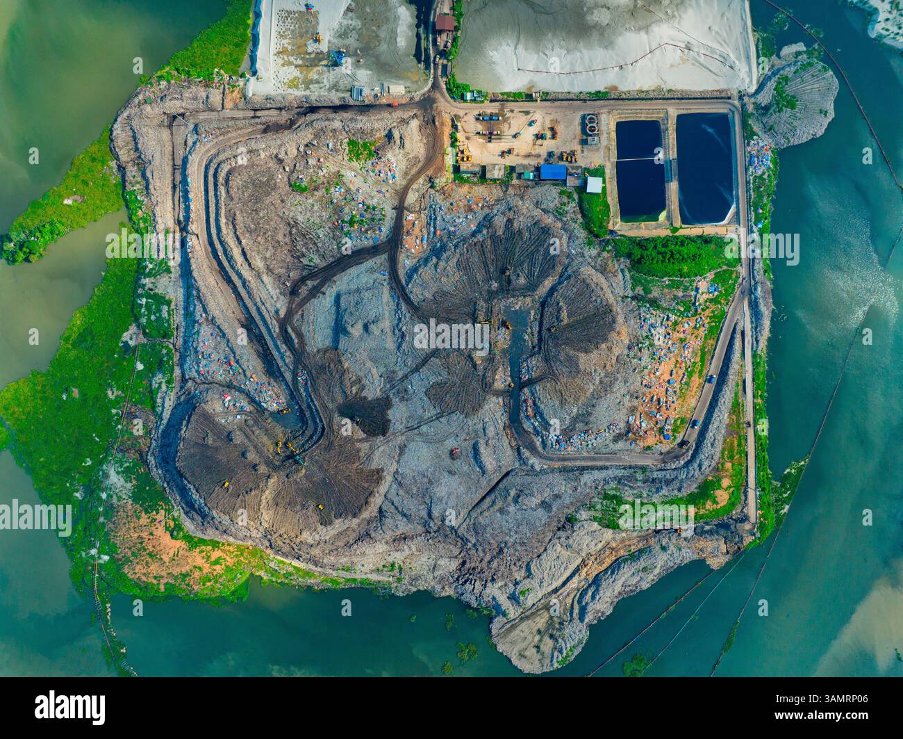 Aerial view of cranes working at the largest waste dumping yard in ...