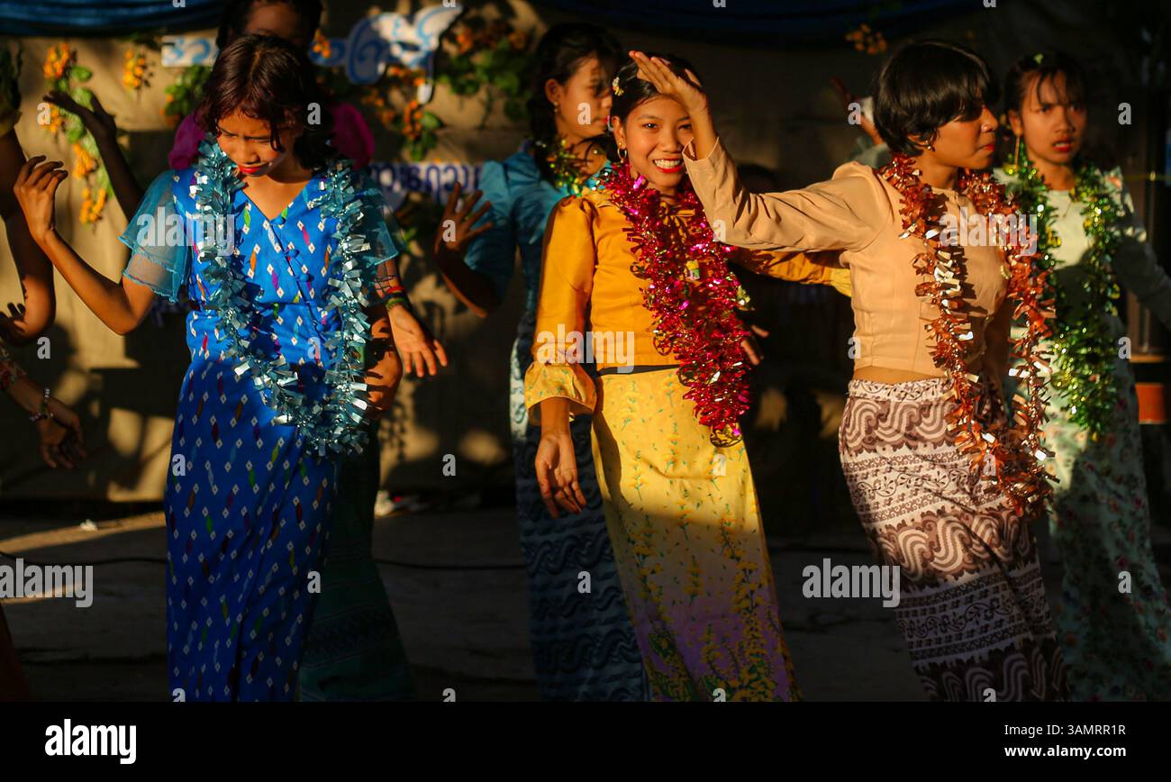 Young women from the Myanmar migrant community perform a traditional ...