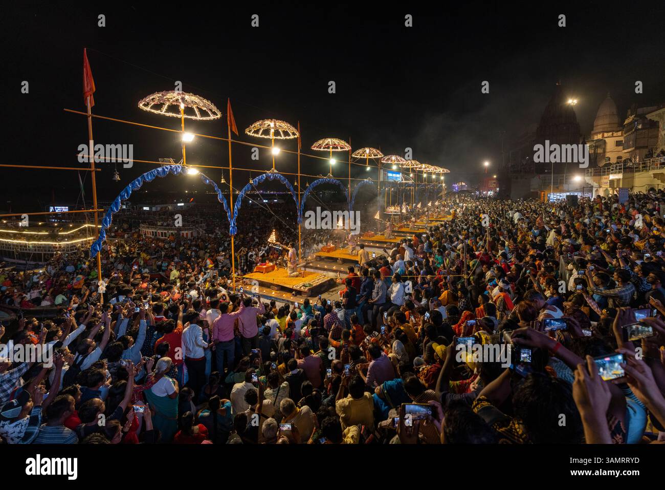 Uttar Pradesh, India - 06 March 2023: Aerial view of people along the Ganges river at night in ...