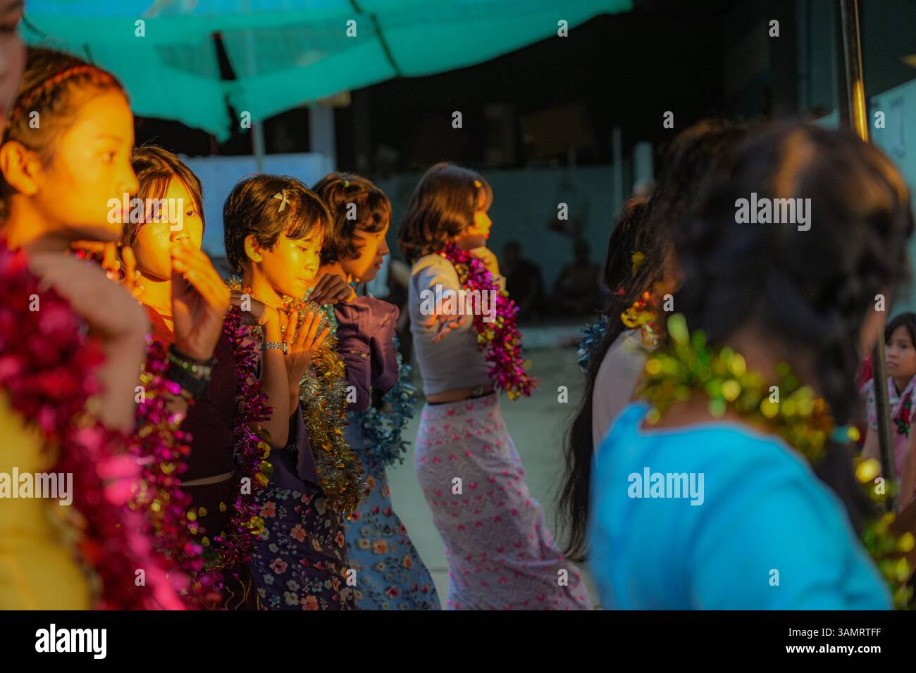 Young women from the Myanmar migrant community perform a traditional ...