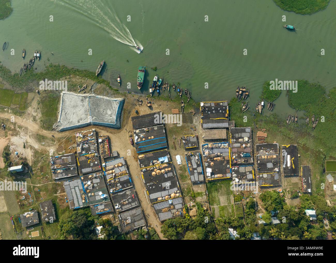 Aerial view of people working in a fish market drying fish at Lalpur ...