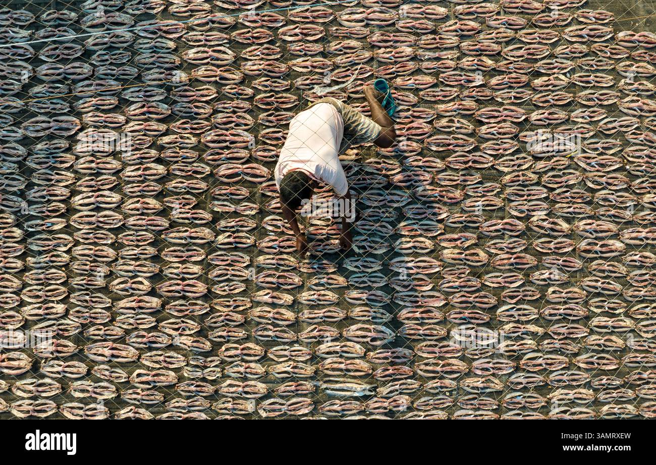 Aerial view of people working in a fish market drying fish at Lalpur ...