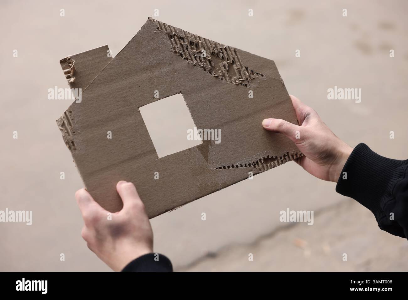 Homeless man with carton house figure outdoors, closeup Stock Photo - Alamy