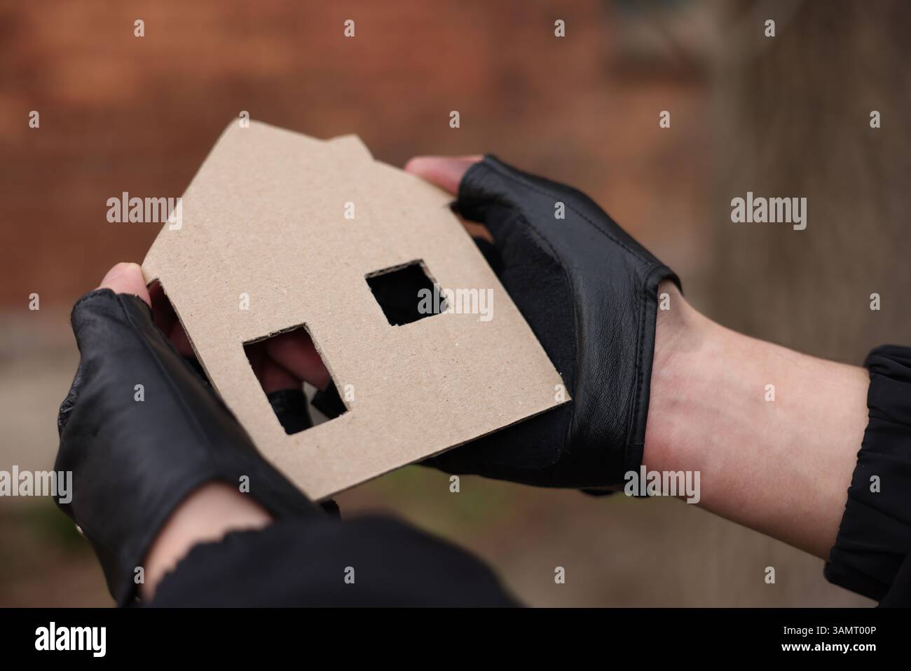 Homeless man with carton house figure outdoors, closeup Stock Photo - Alamy