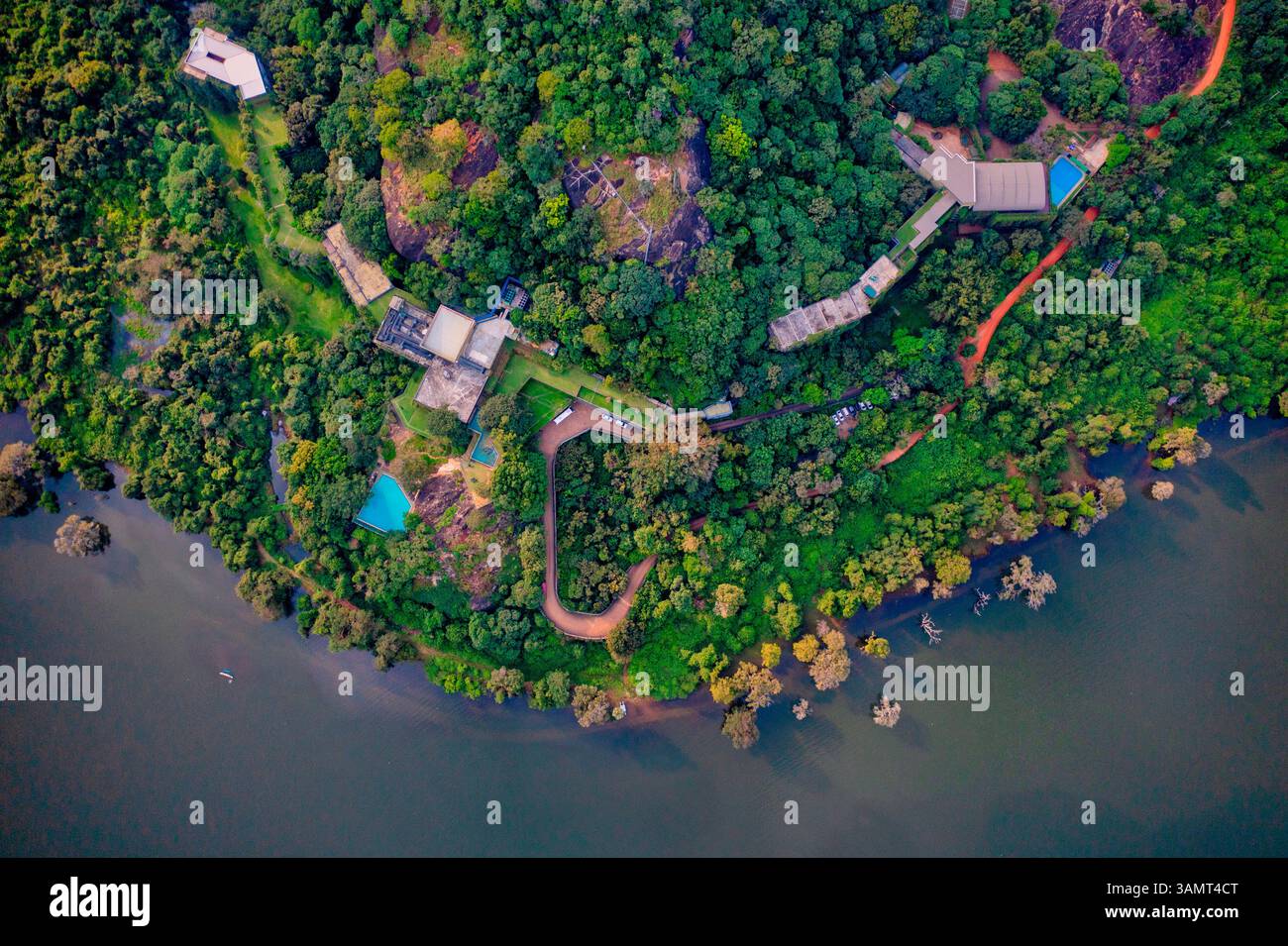 Aerial view of buildings along the coast with forest at Kandalama ...