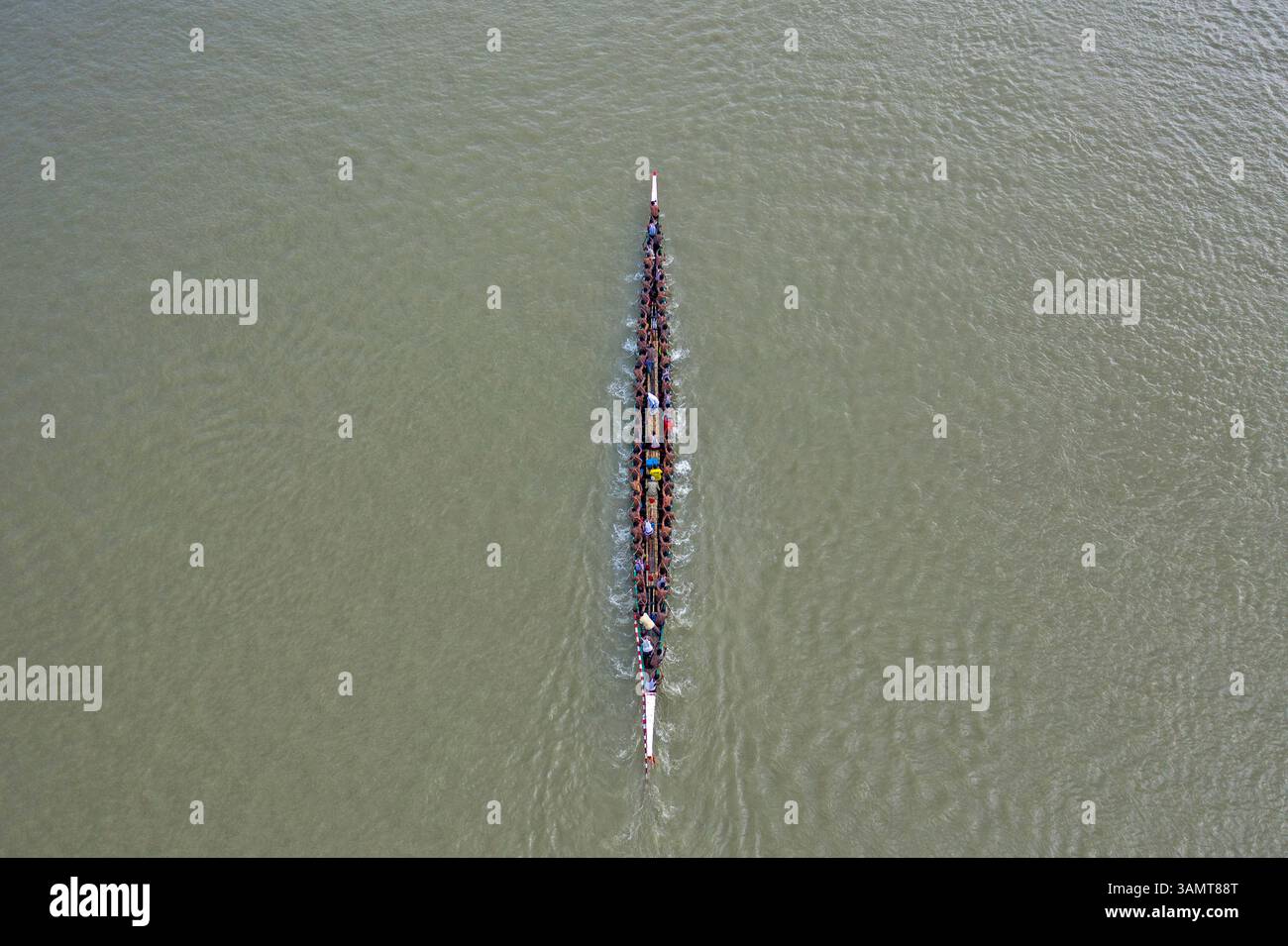 Aerial view of a long canoe for sport activities crossing Meghna river ...