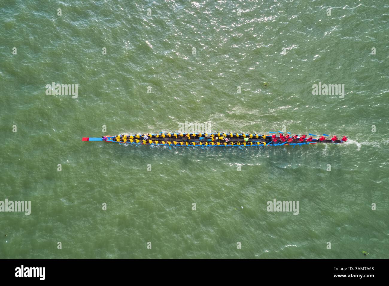Aerial view of a long canoe for sport activities crossing Meghna river ...