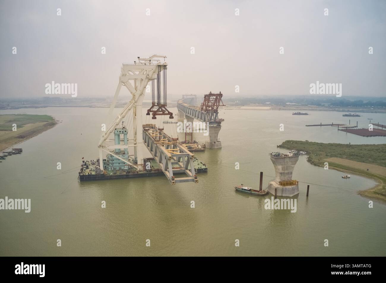 Aerial view of a building site while assembling the Padma bridge, the longest rail and highway ...