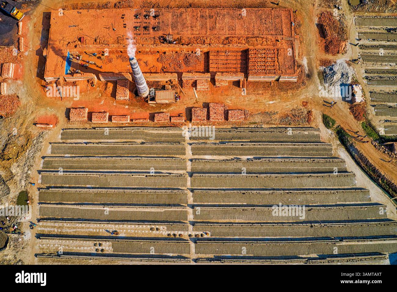 Aerial view of a quarry from a brick factory with some trucks parked ...