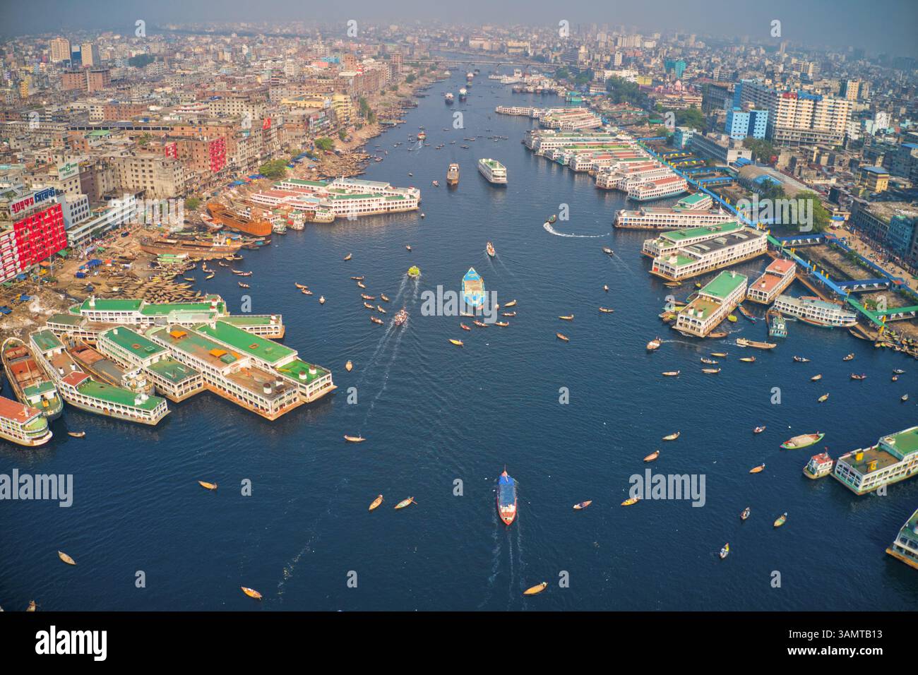 Aerial view of several boats under construction docked along Buriganga river in Keraniganj with ...