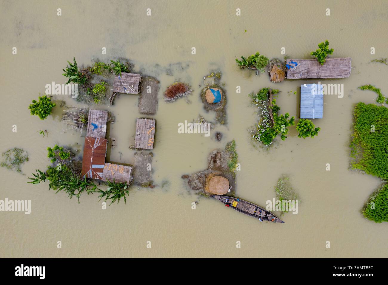 Aerial view of a few wooden huts in Brahmaputra river swamp near ...