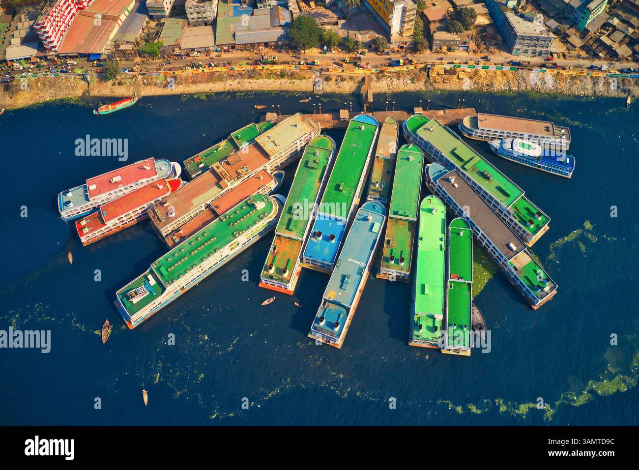 Aerial view of colourful ferry boat docket at small wharf along Buriganga river in Keraniganj ...