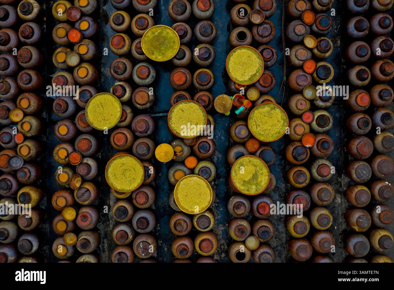 Aerial view of people working in a factory processing Soya source ...