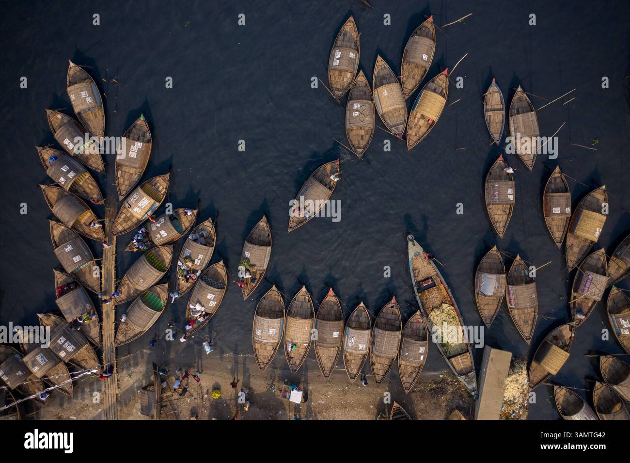 Aerial view of traditional fishing boat docked along Shitalakshya river in Bandar township ...