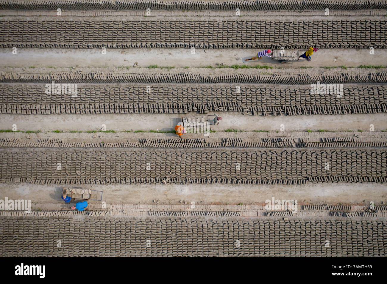 Aerial view of a brick factory from above, people working arranging the ...