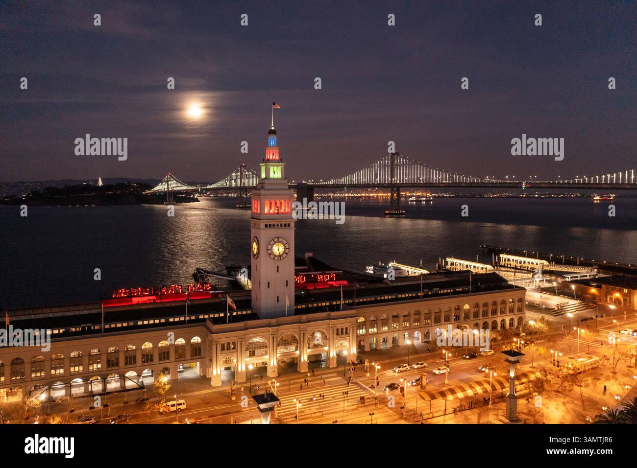 Aerial view of illuminated skyline with Bay Bridge and Ferry Building ...