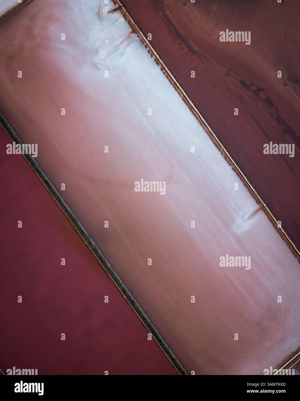 Aerial view of pink colored reservoirs for extraction of the salt near ...