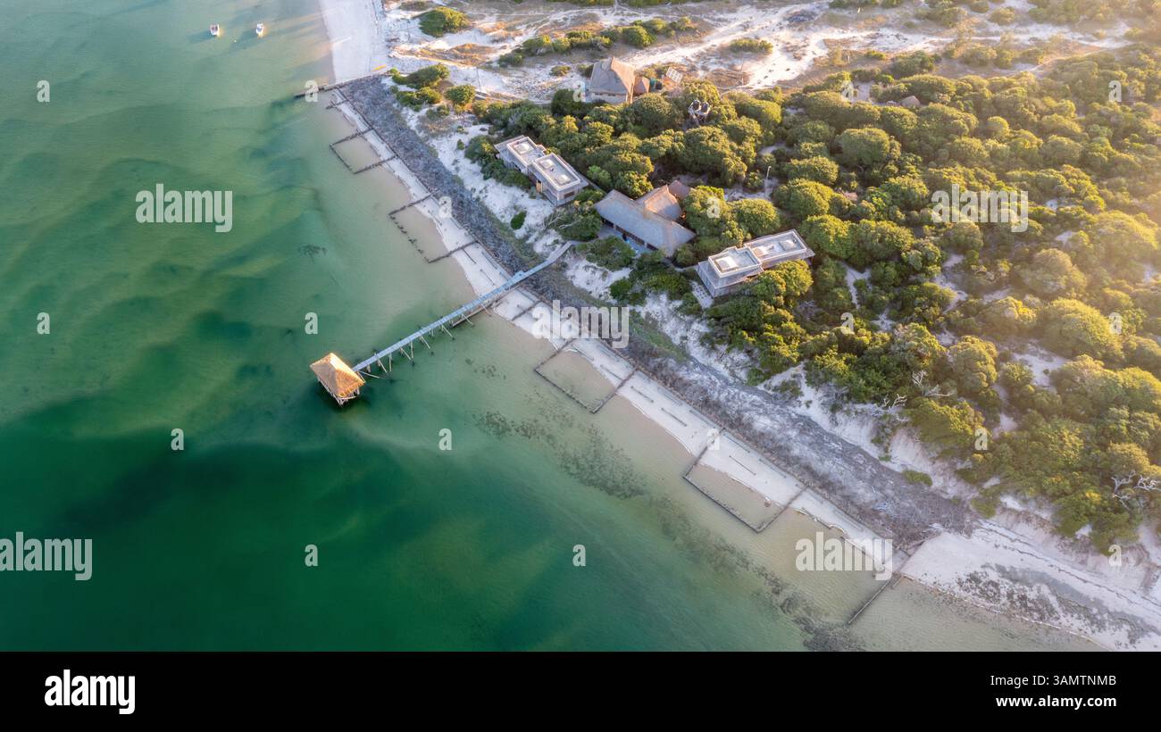 Aerial view of Thatched Pier and Ocean with Tropical Beach and Forest ...