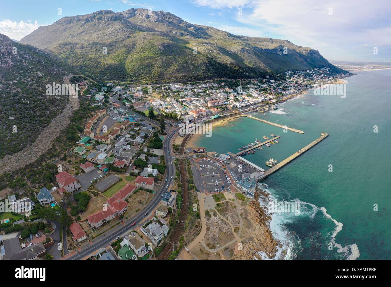 Aerial view of harbour, ocean, town, and hills, Kalk Bay, Western Cape ...