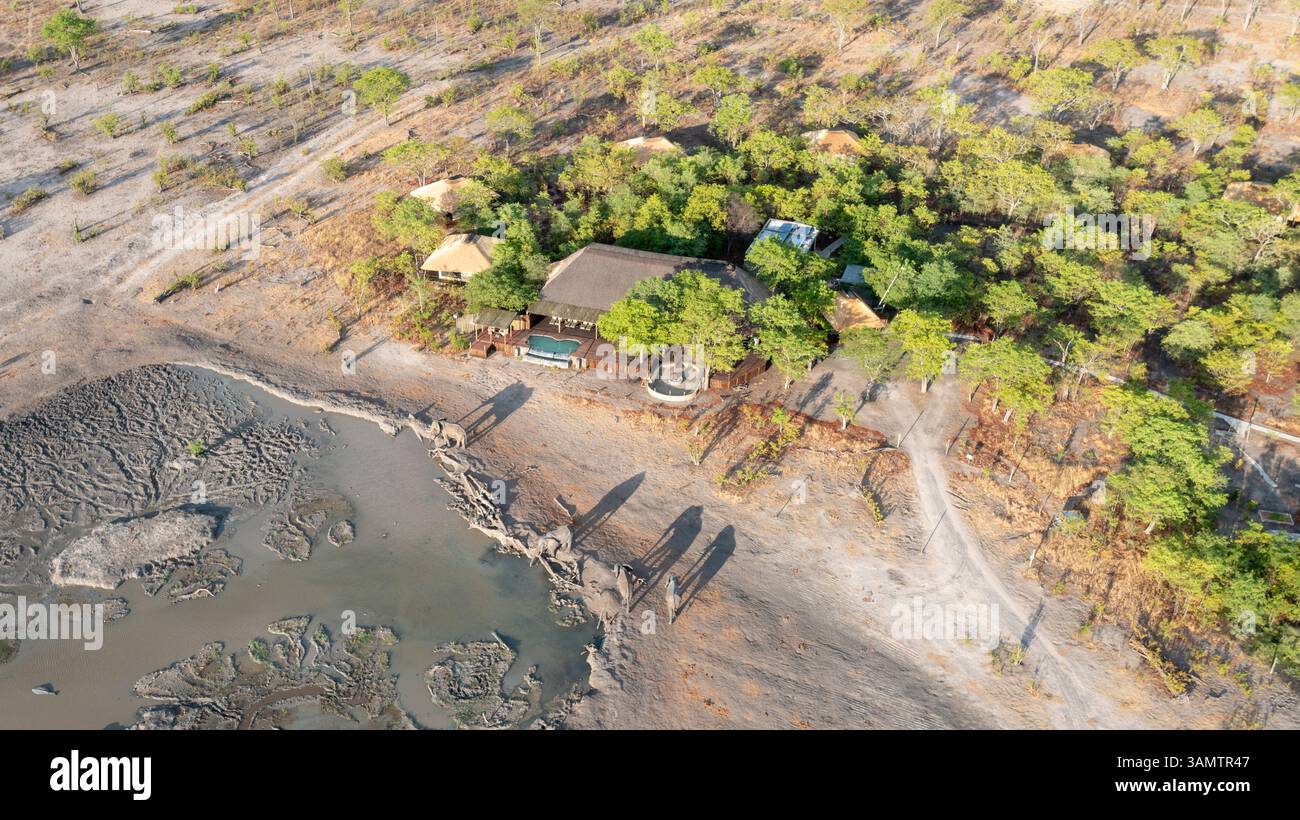 Aerial view of remote safari lodge and waterhole in Kazuma Forest ...