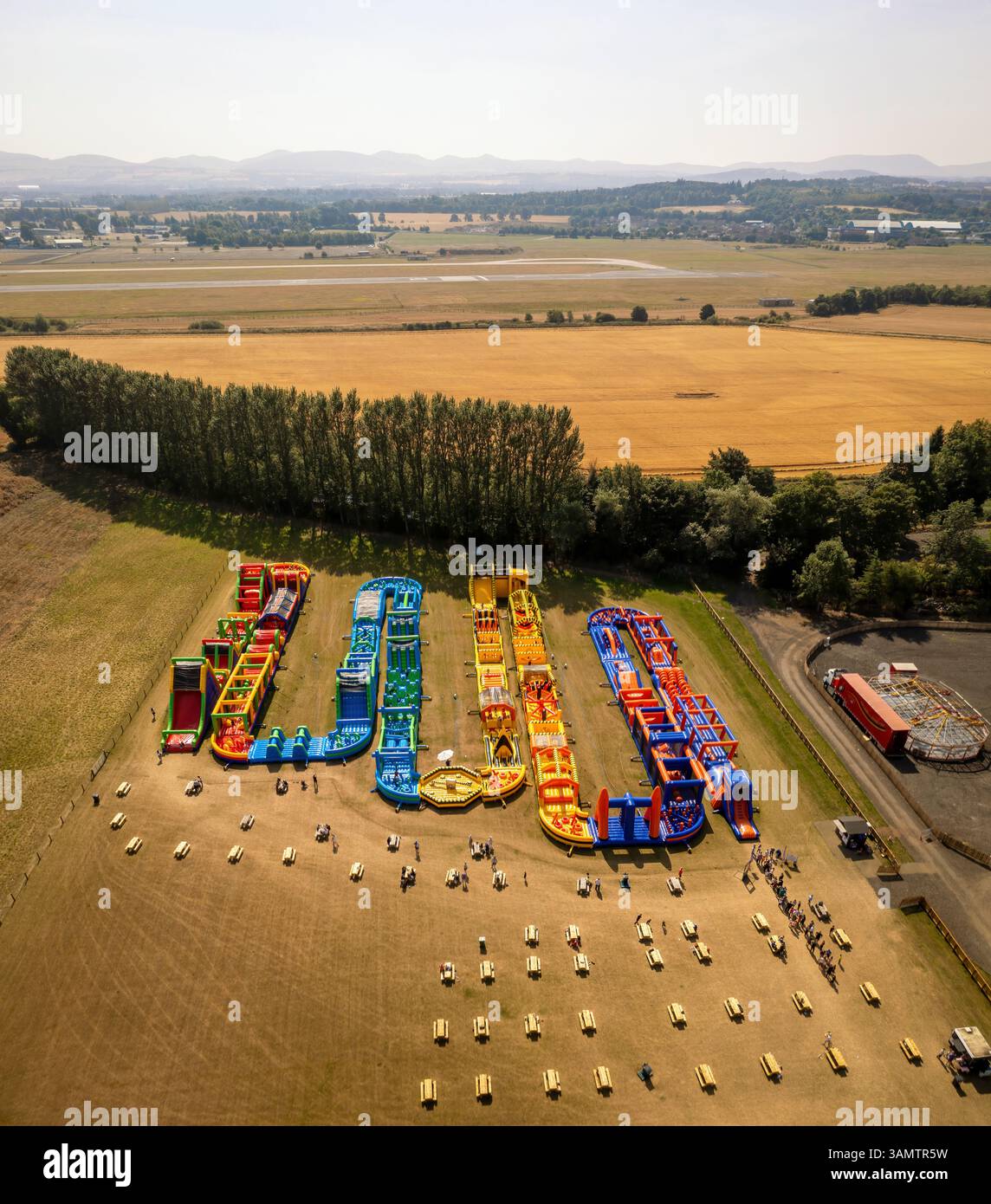 Aerial view of colorful adventure park with inflatable obstacles in ...