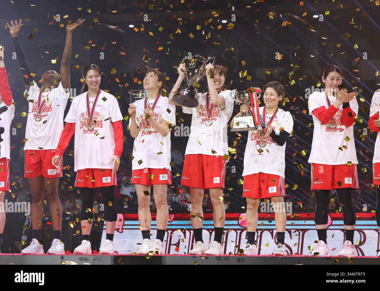 Members of Fujitsu celebrate after winning the women's basketball W ...