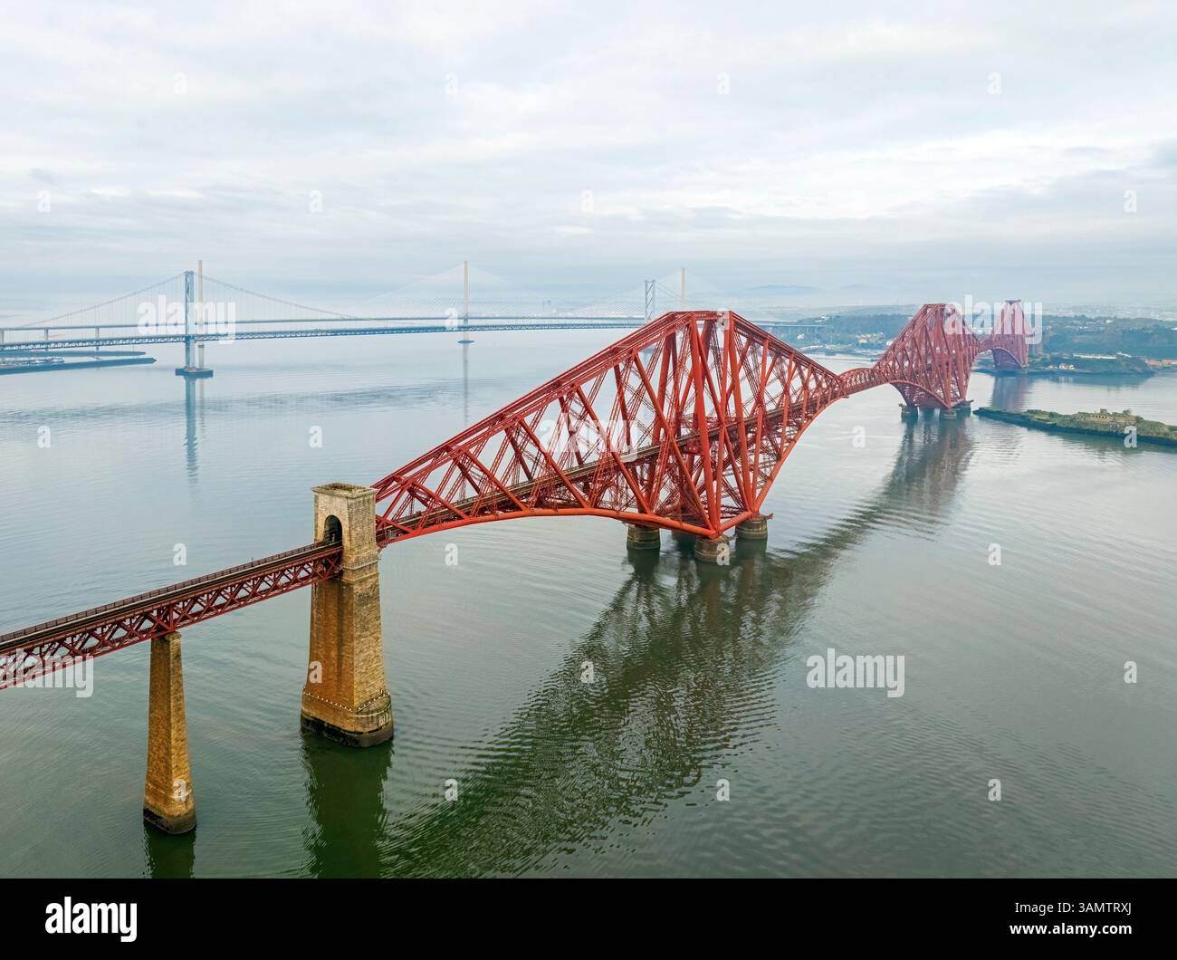 Aerial view of the iconic Forth Rail Bridge spanning the tranquil river ...