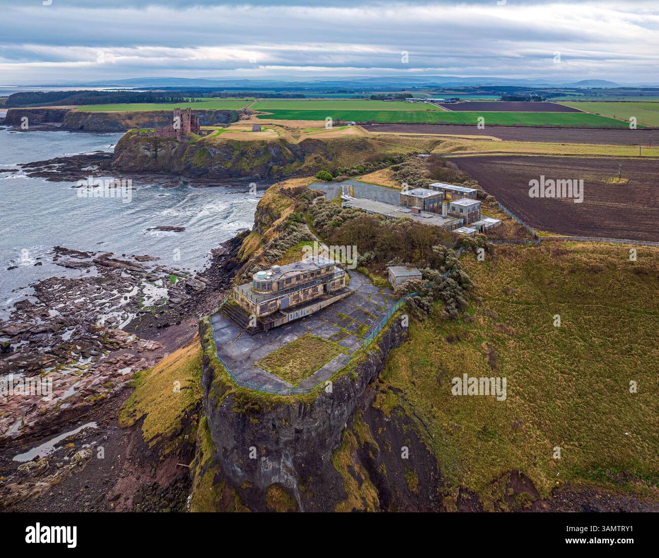 Aerial view of gin head radar station on rugged cliff overlooking the ...