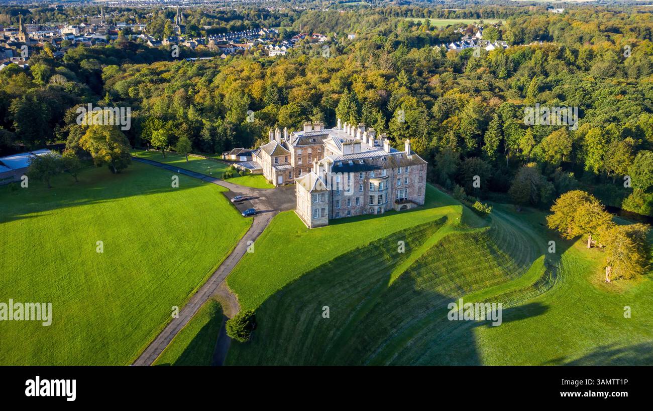 Aerial view of historic castle surrounded by forest in Dalkeith Country ...