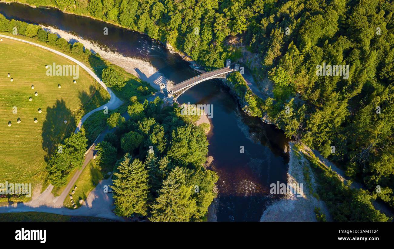 Aerial view of river, bridge, forest, meadow, and road in serene ...