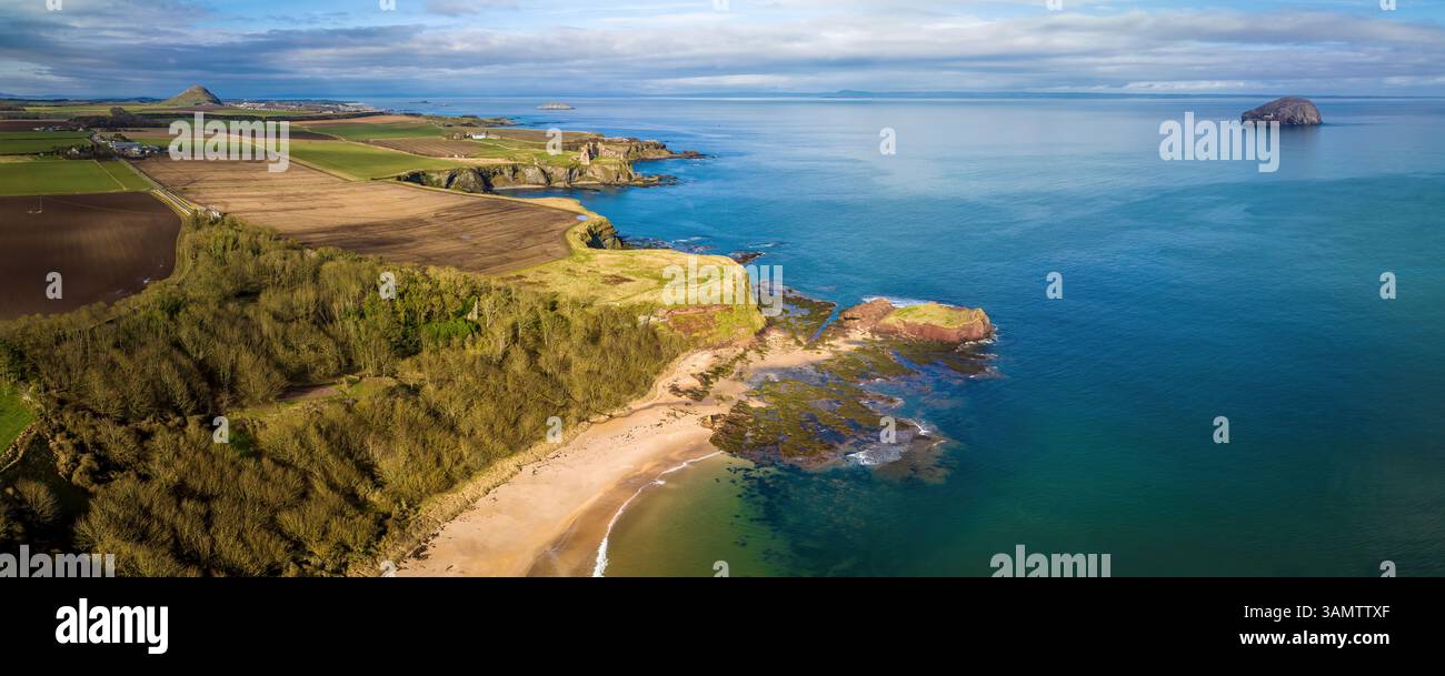 Aerial view of rugged coastal landscape and serene Seacliff Beach ...