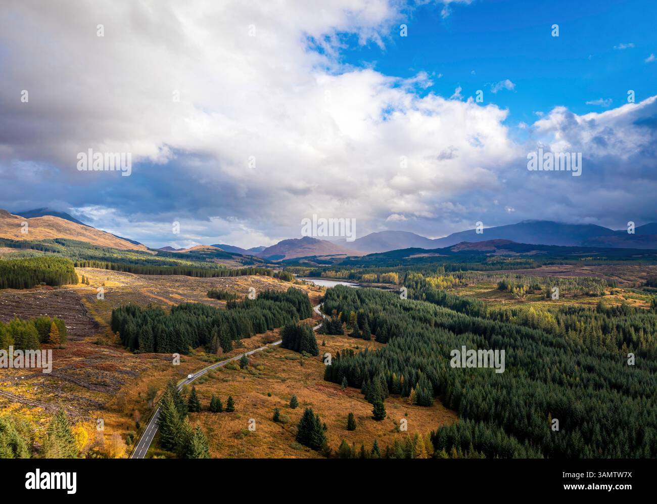 Aerial view of River Spean surrounded by forest, road, and mountains ...