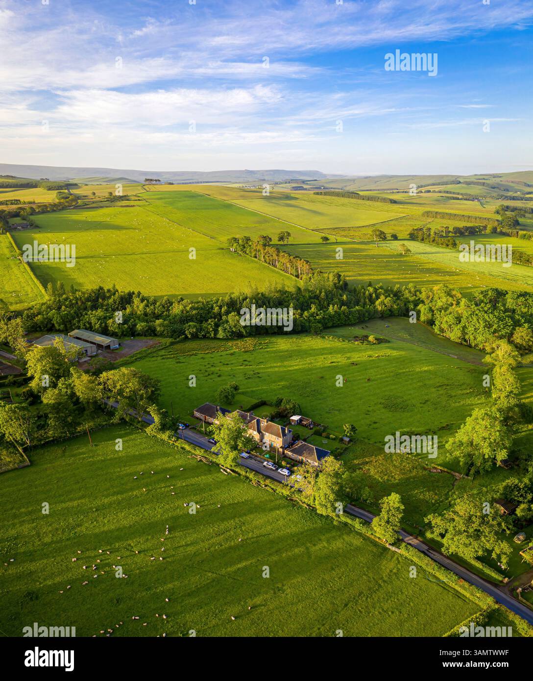 Aerial view of serene countryside with rolling hills and village of ...