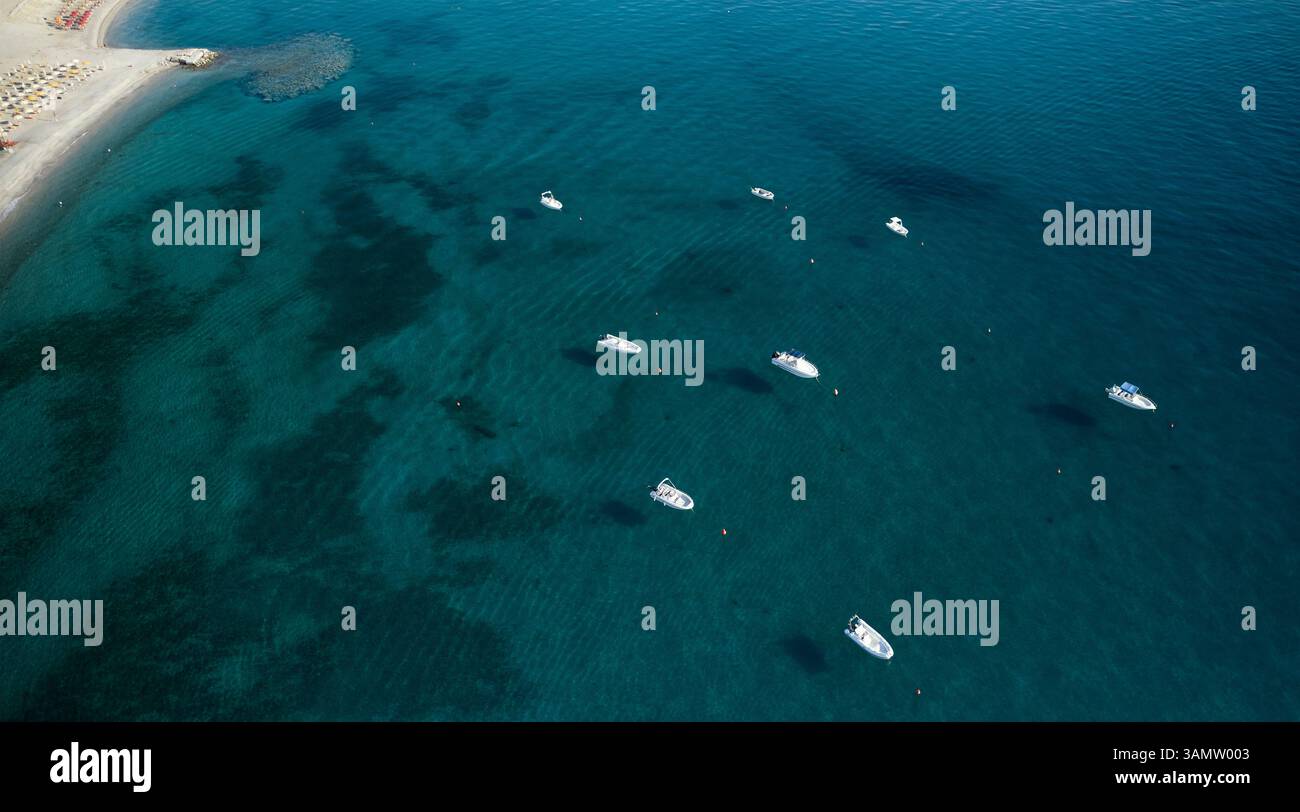 Aerial view of a group of speedboats surrounded by a transparent blue ...