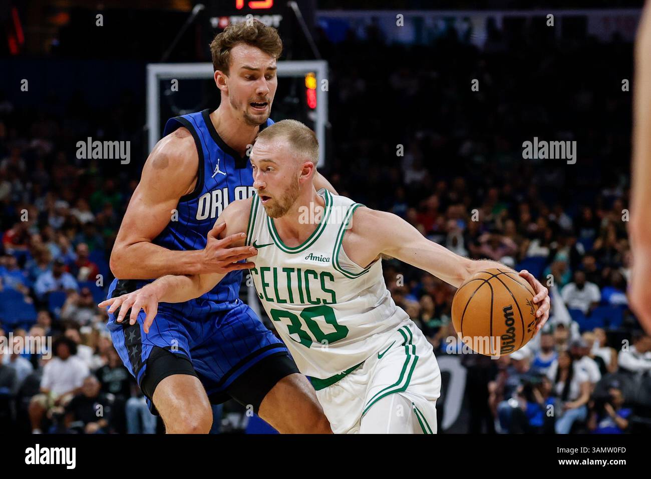 Boston Celtics forward Sam Hauser (30) drives against Orlando Magic ...