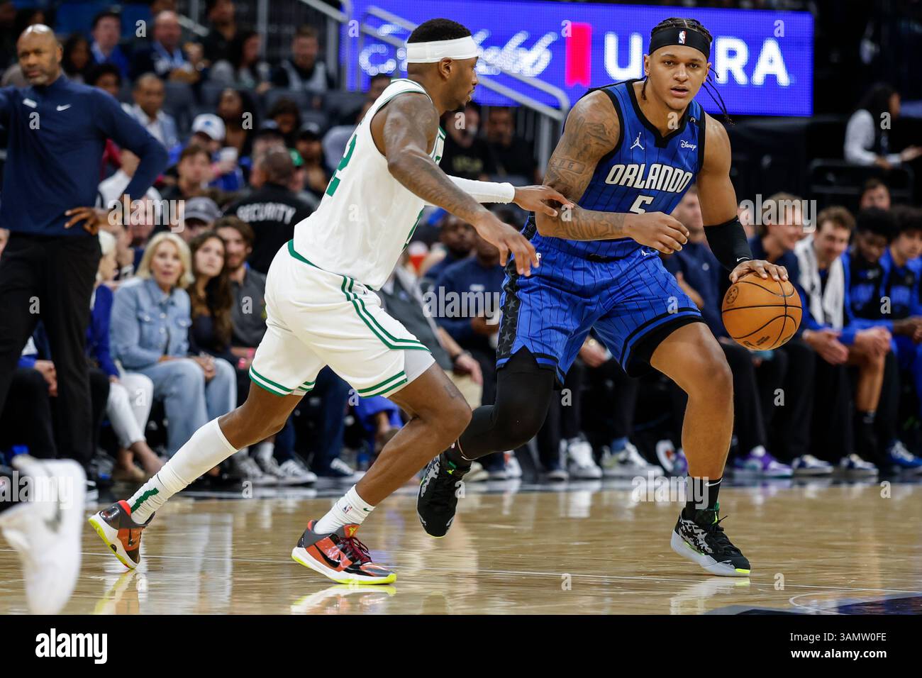Orlando Magic forward Paolo Banchero, right, brings the ball downcourt against Boston Celtics ...