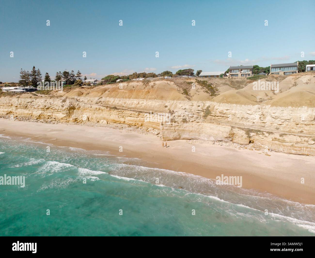 Aerial view of Port Willunga beach with two people walking on the beach ...