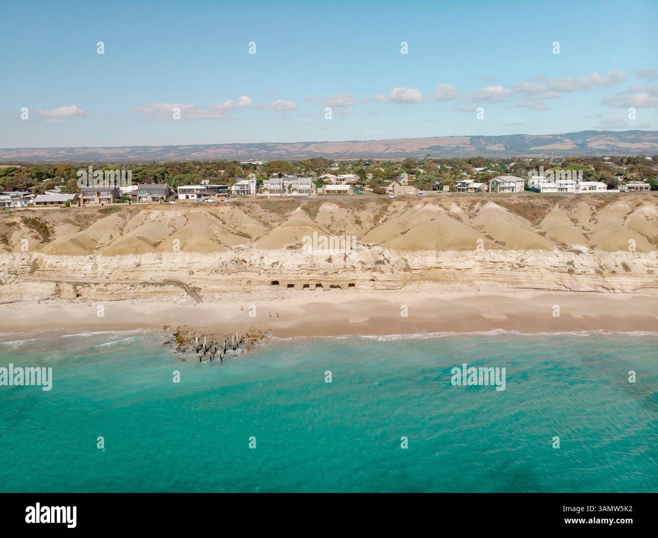 Aerial view of Port Willunga beach with caves in the cliff wall and ...