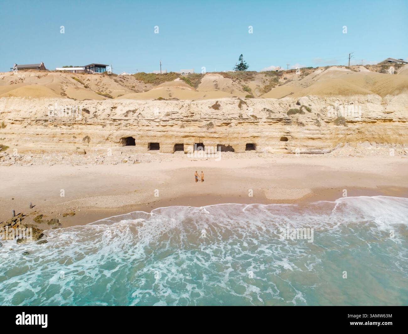 Aerial view of Port Willunga beach with two people holding hands on the ...