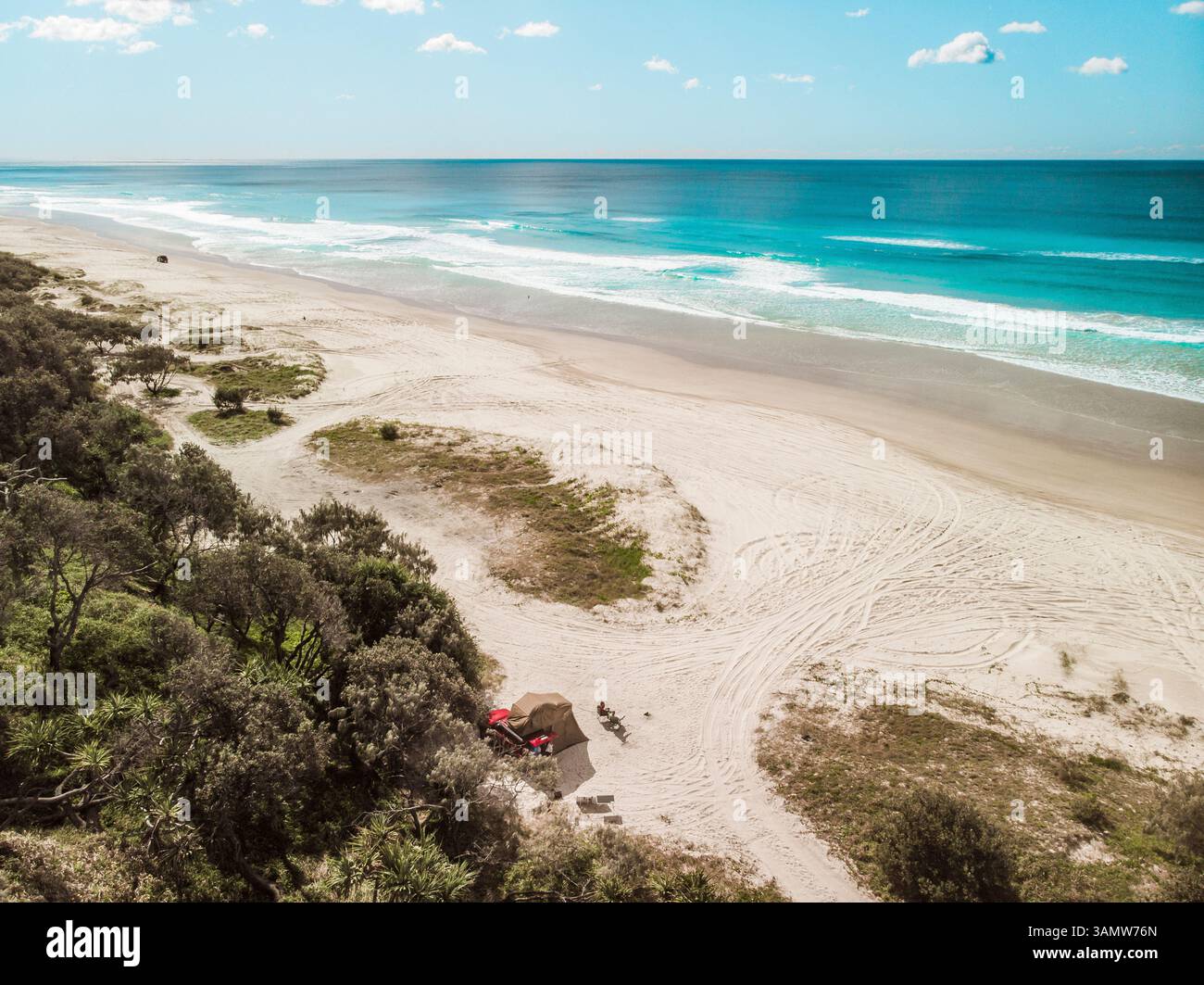 Aerial view of people camping and driving on the beach in the Cooloola ...