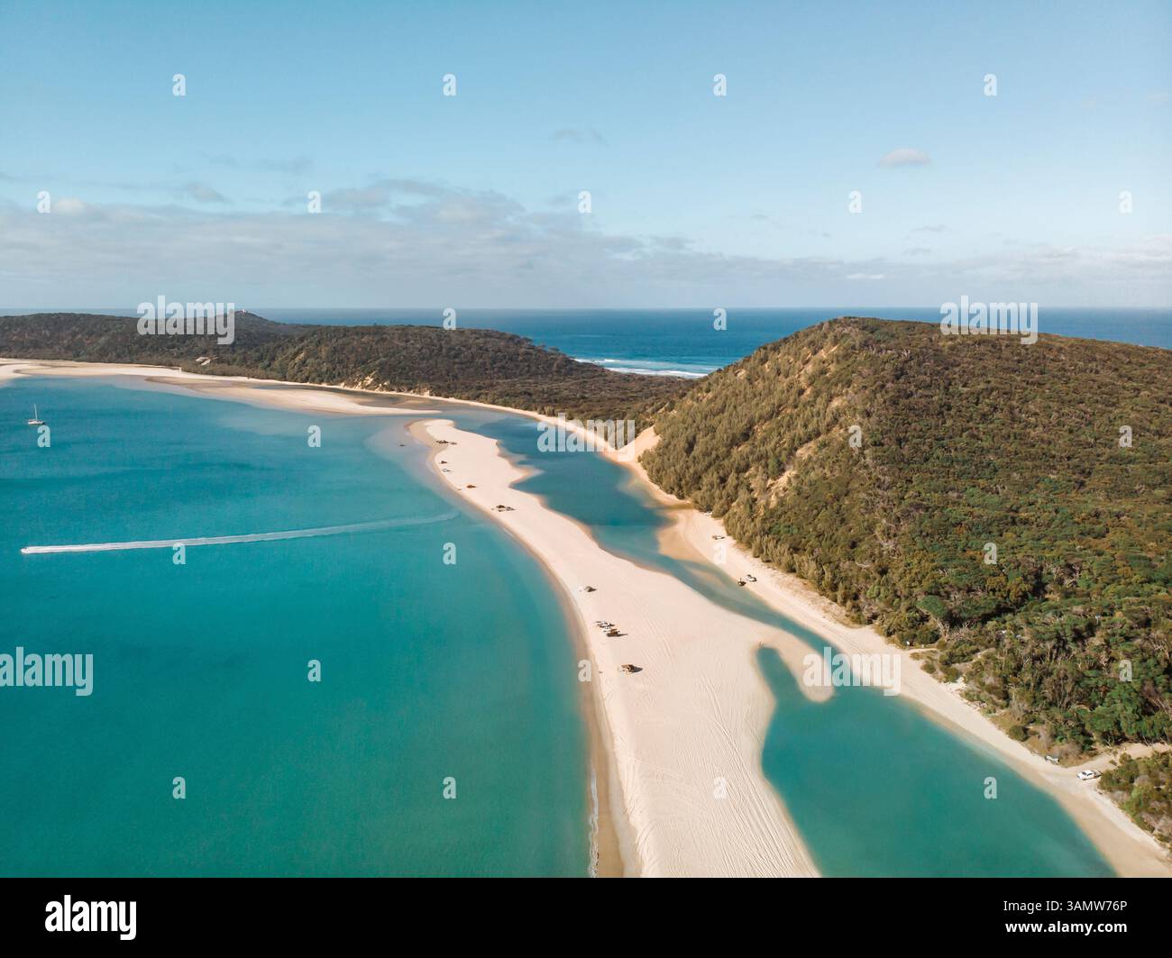 Aerial view of a beach with natural lagoons and cars parked on the ...