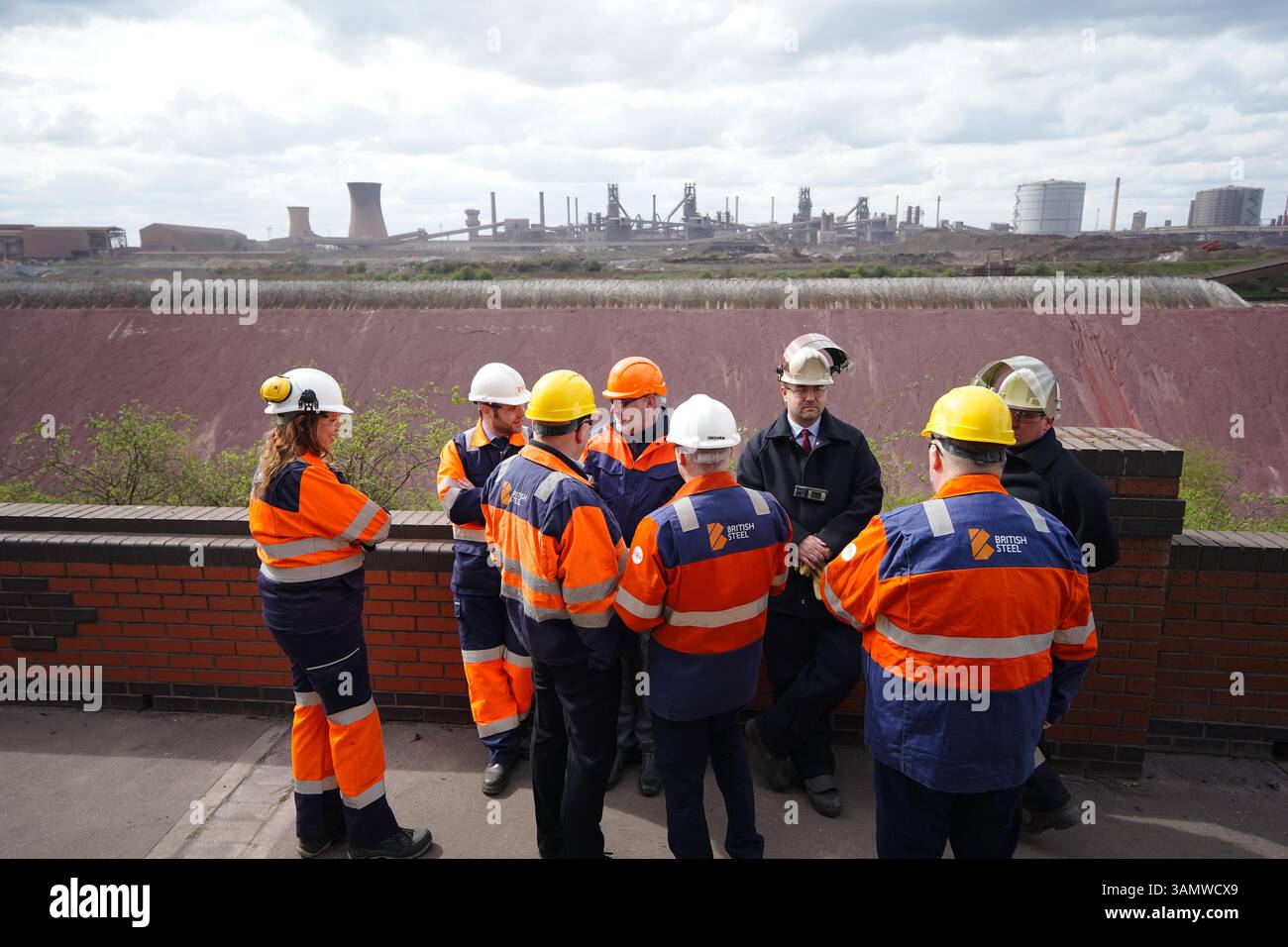 Members of staff in front of blast furnaces during Deputy Prime ...