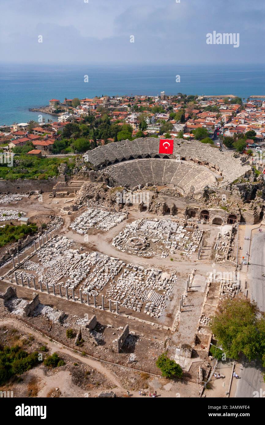 Aerial view of ancient ruins and a historic amphitheater by the sea ...