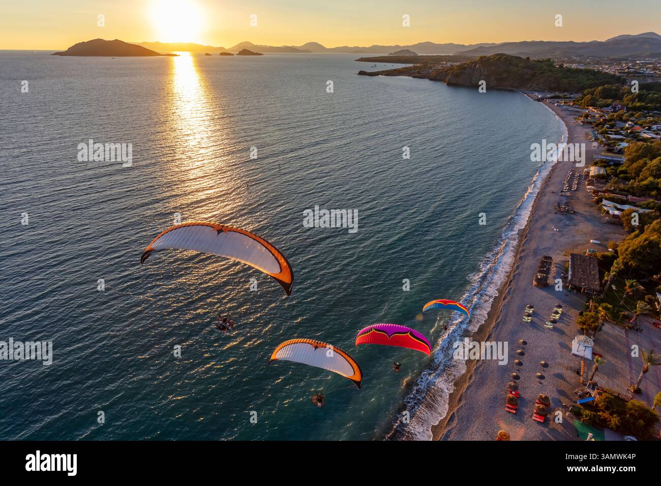 Aerial view of paramotors flying in formation at Calis Beach of Fethiye ...
